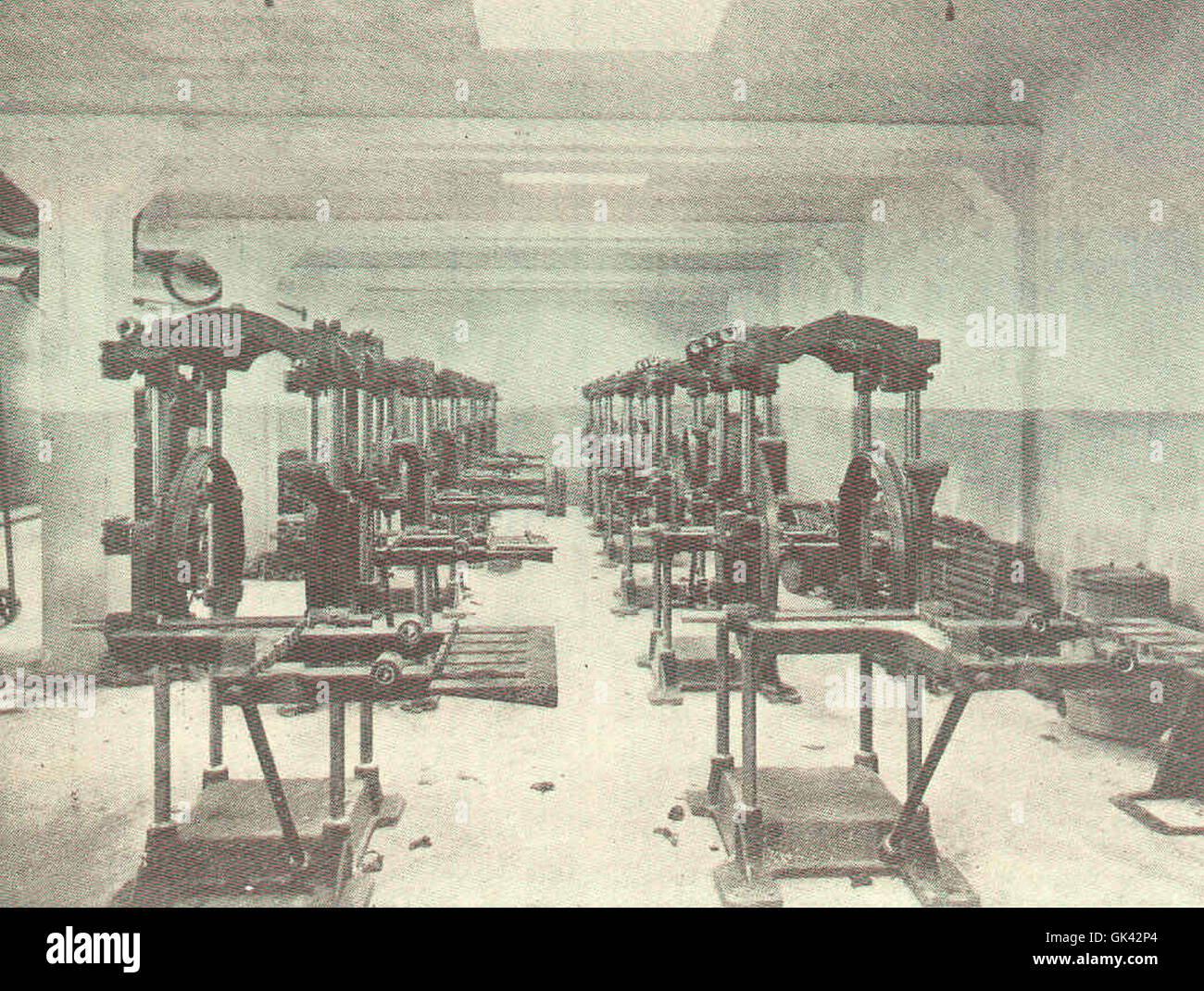 The image shows workers in the assembling department of a new factory ...