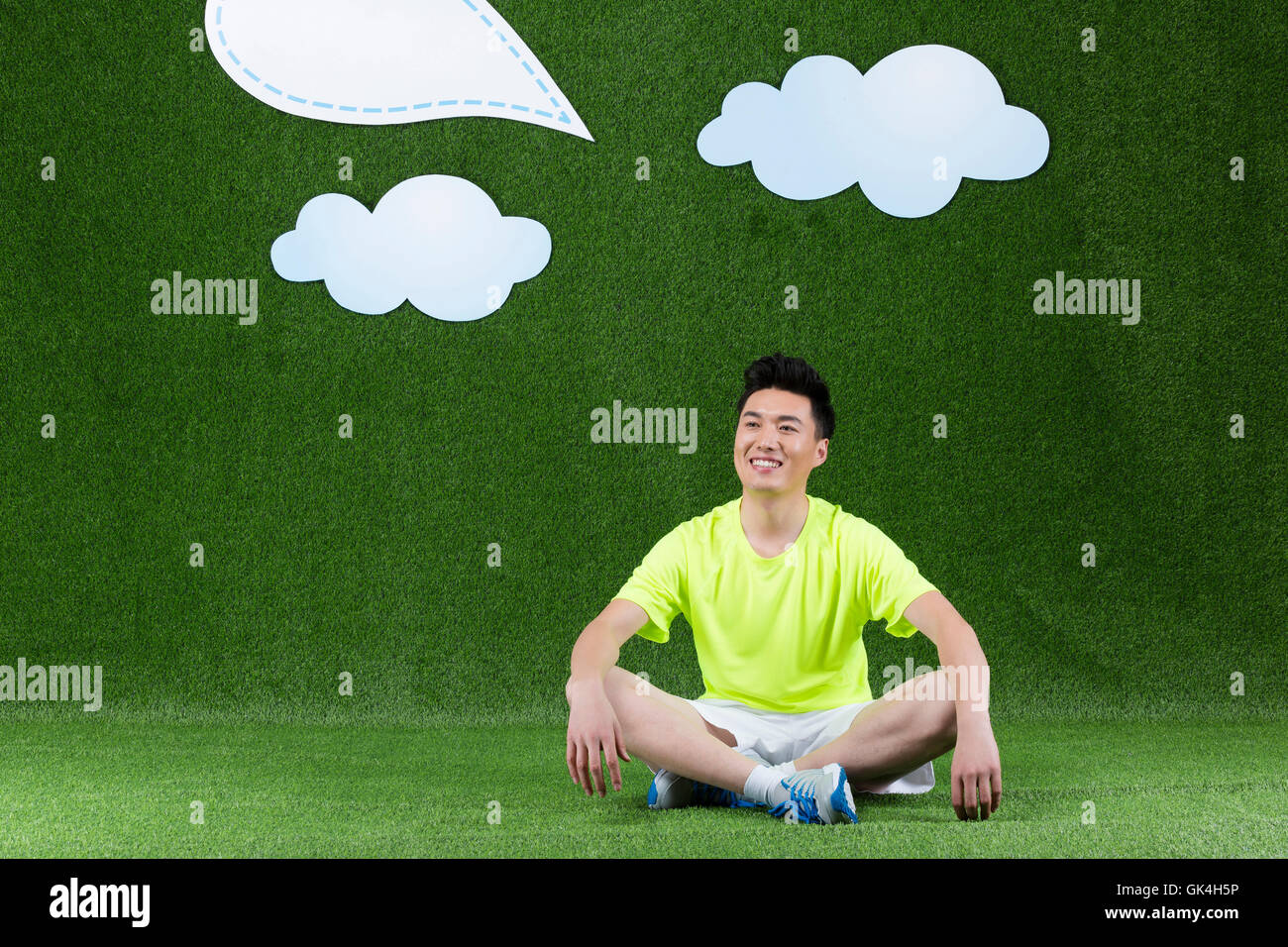 Creative young man sitting on the grass Stock Photo - Alamy