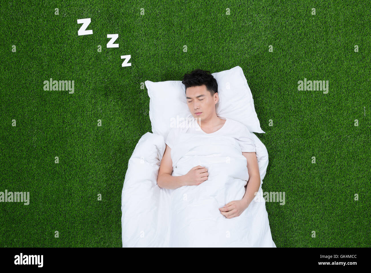 Creative meadow sleeping young men Stock Photo - Alamy