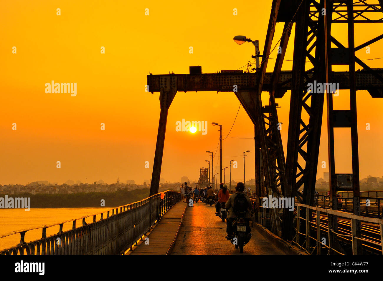 Hanoi, Vietnam - 18 November,2012: People go home in the sunset at Long ...