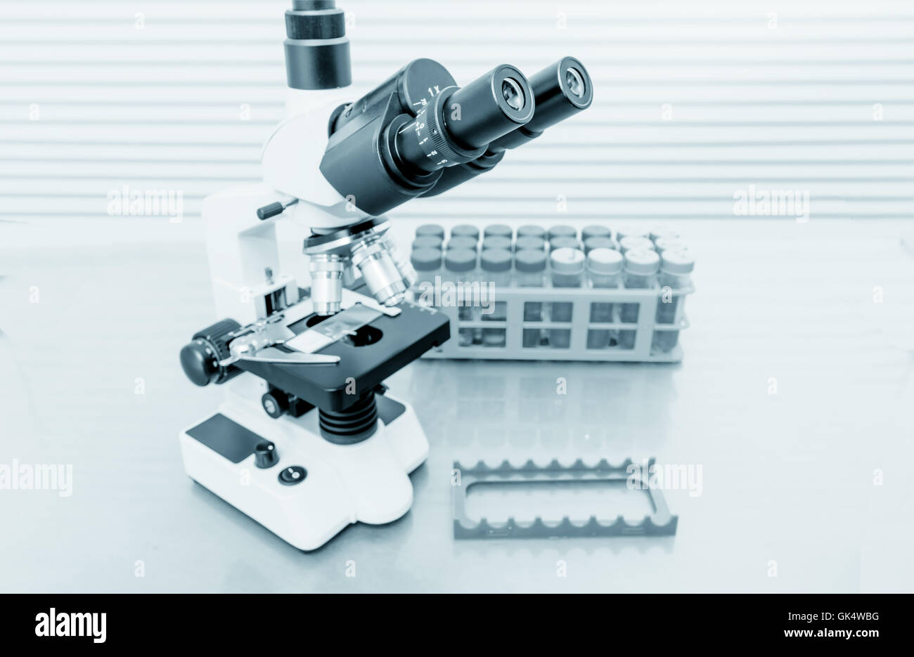 Microscope and test tubes in laboratory, Blue toned image Stock Photo ...