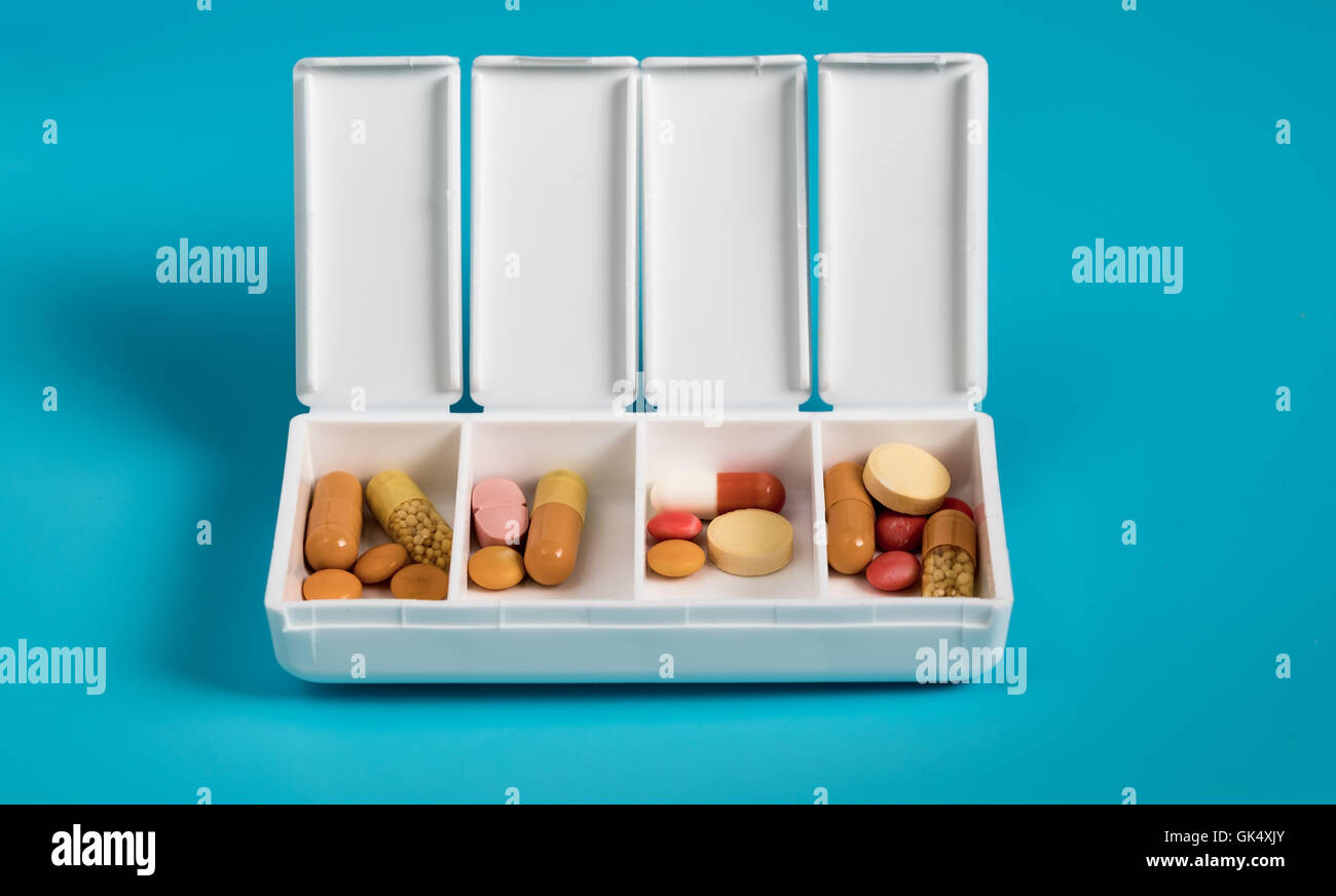 Tablets and capsules in the dispenser Stock Photo - Alamy
