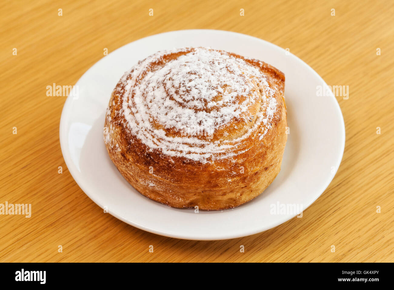 Powdered sugar sweet roll bun on table Stock Photo - Alamy