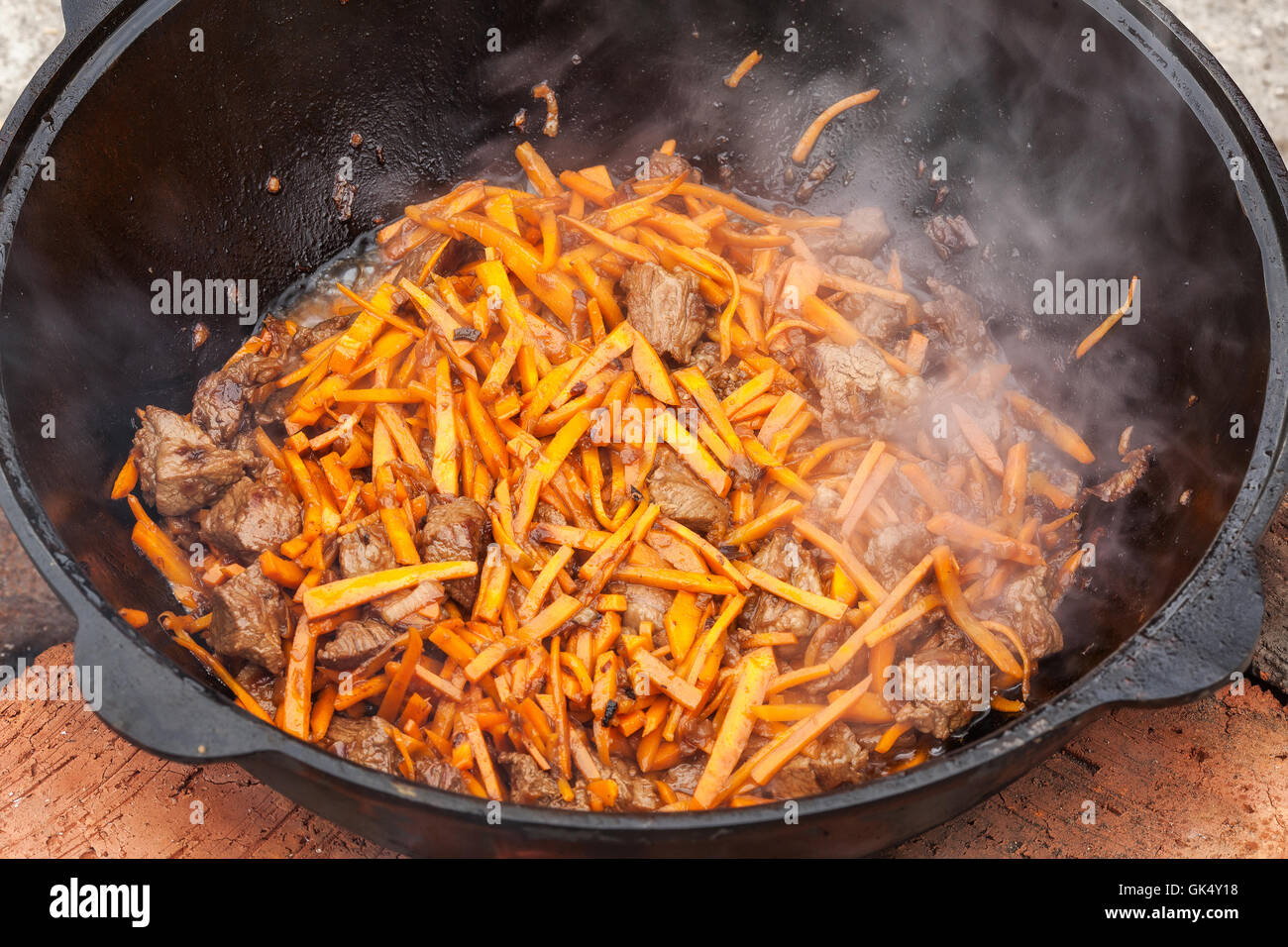 Pilaf, pilaw, plov, rice with meat in pan. Cooking process Stock Photo ...
