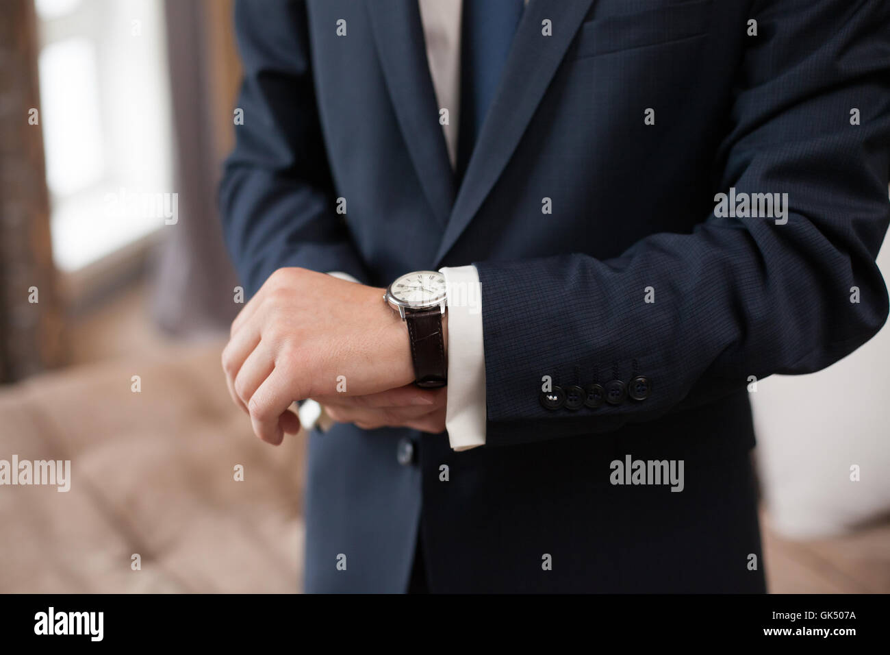 Man with suit and watch on hand hi-res stock photography and images - Alamy