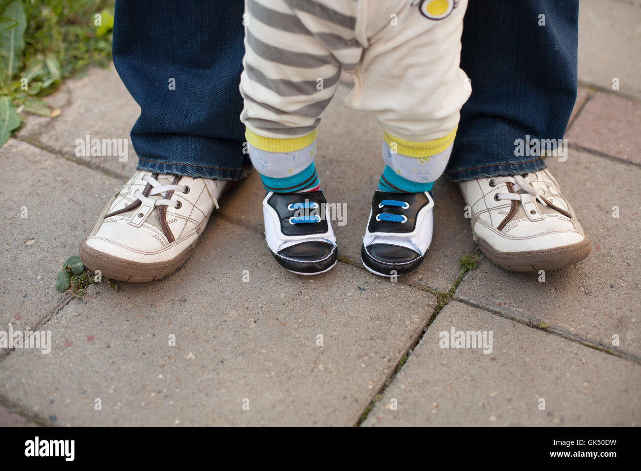 Legs of father and son, making first steps Stock Photo - Alamy