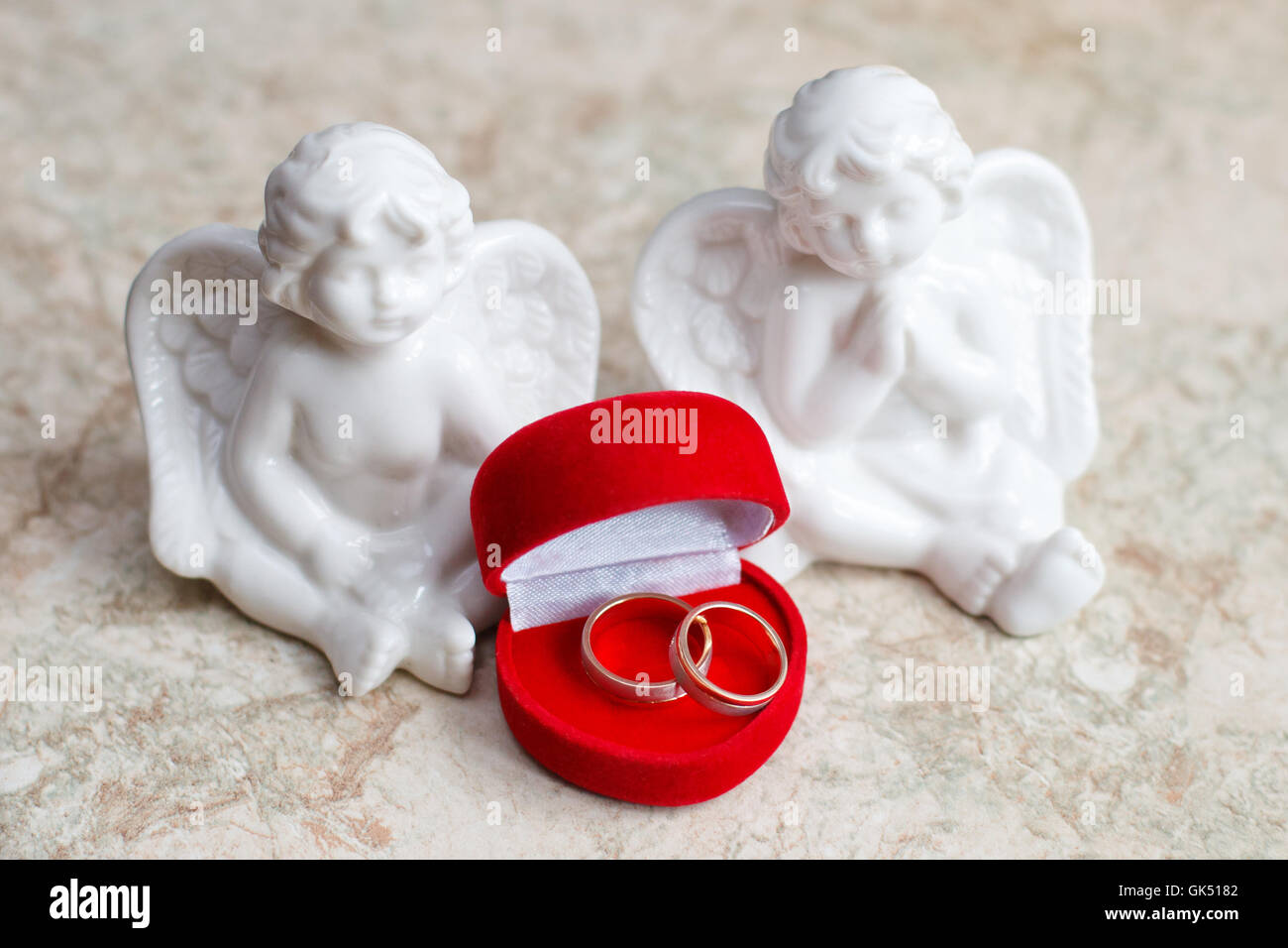 Two angels with golden rings. Romantic composition for wedding day ...