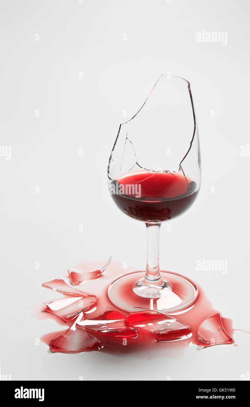 Broken Red Wine tasting glass with wine Stock Photo - Alamy