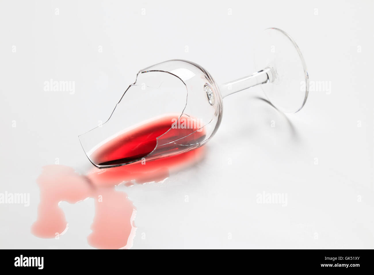 Broken Red Wine tasting glass with wine Stock Photo - Alamy