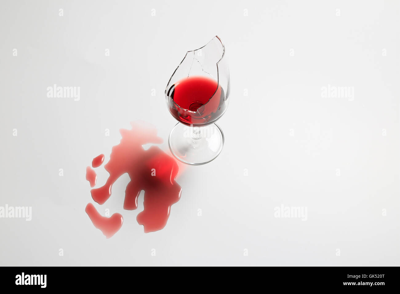 Broken Red Wine tasting glass with wine Stock Photo - Alamy