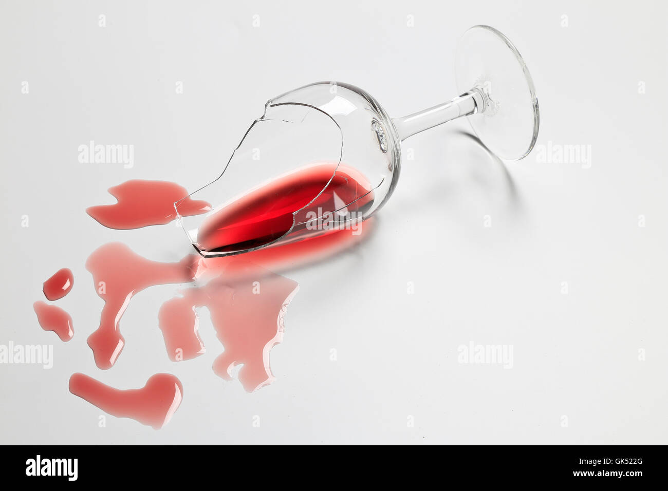 Broken Red Wine tasting glass with wine Stock Photo - Alamy