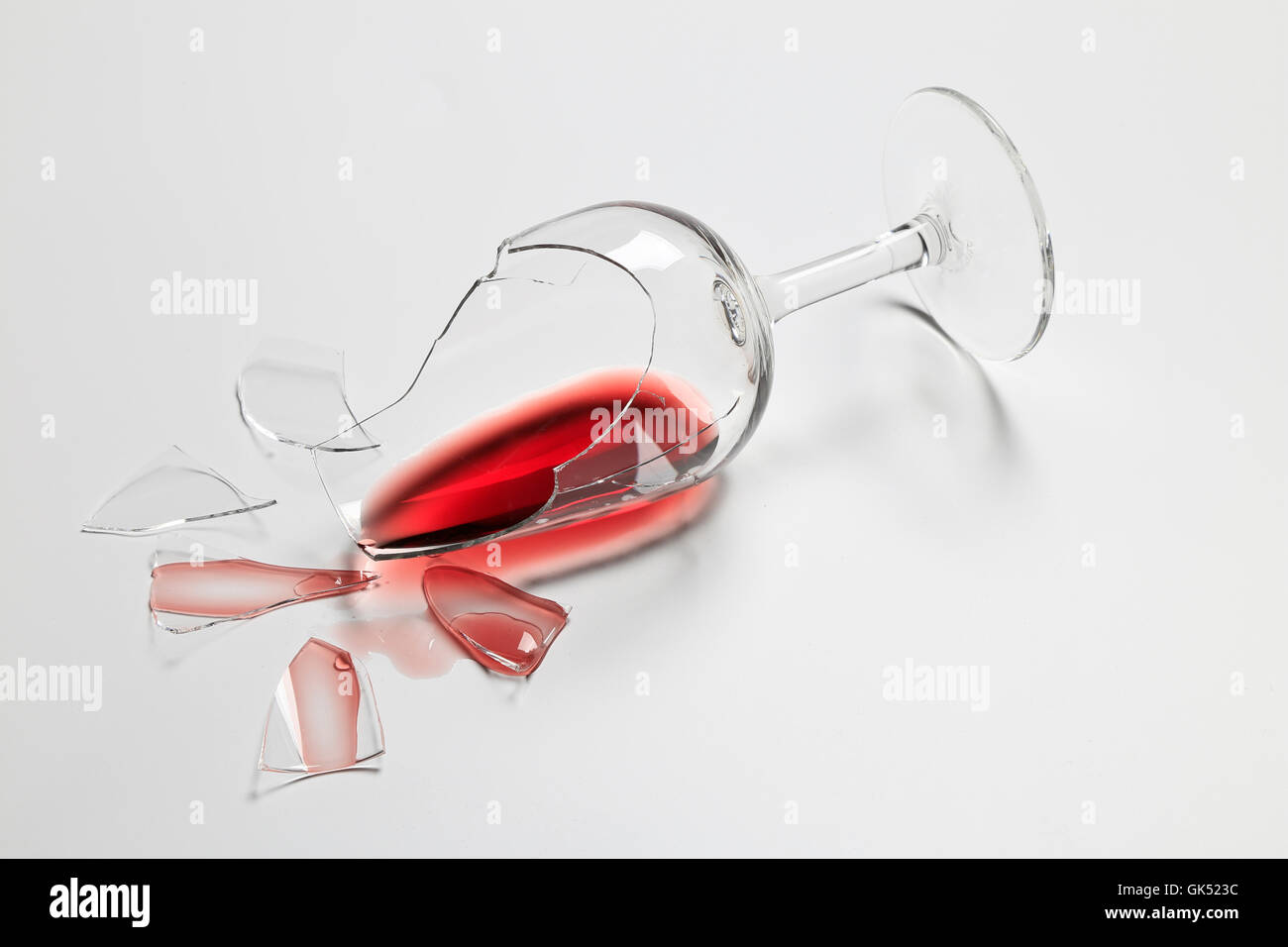 Broken Red Wine tasting glass with wine Stock Photo - Alamy