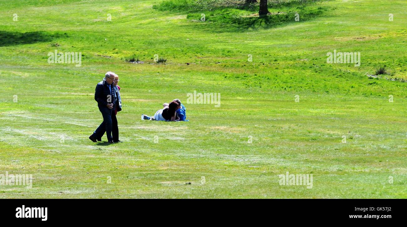 People enjoying the warm spring sunshine on Hampstead Heath Featuring ...
