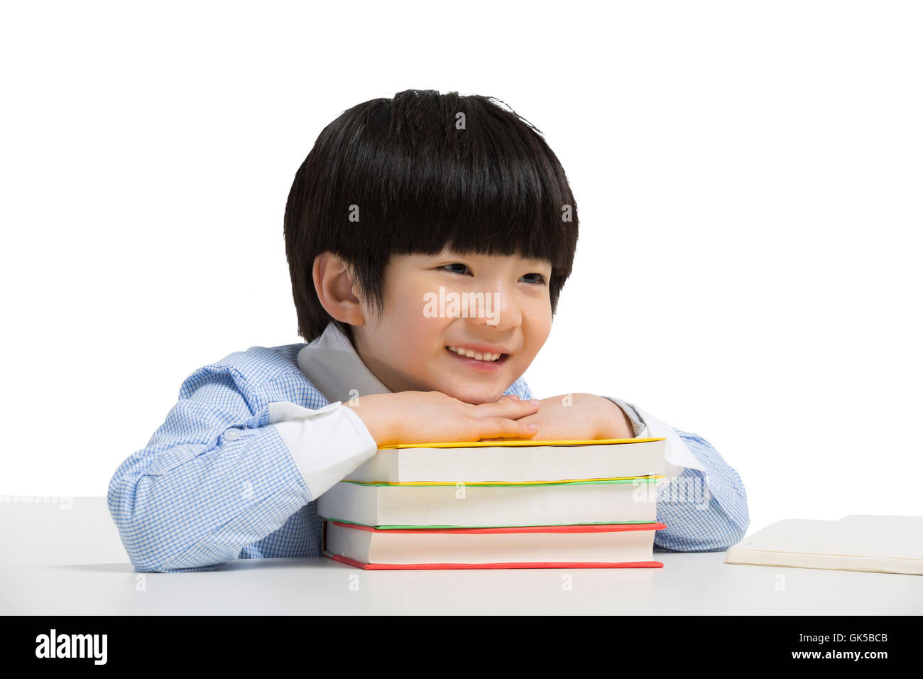 Little boy lying on a desk Stock Photo - Alamy