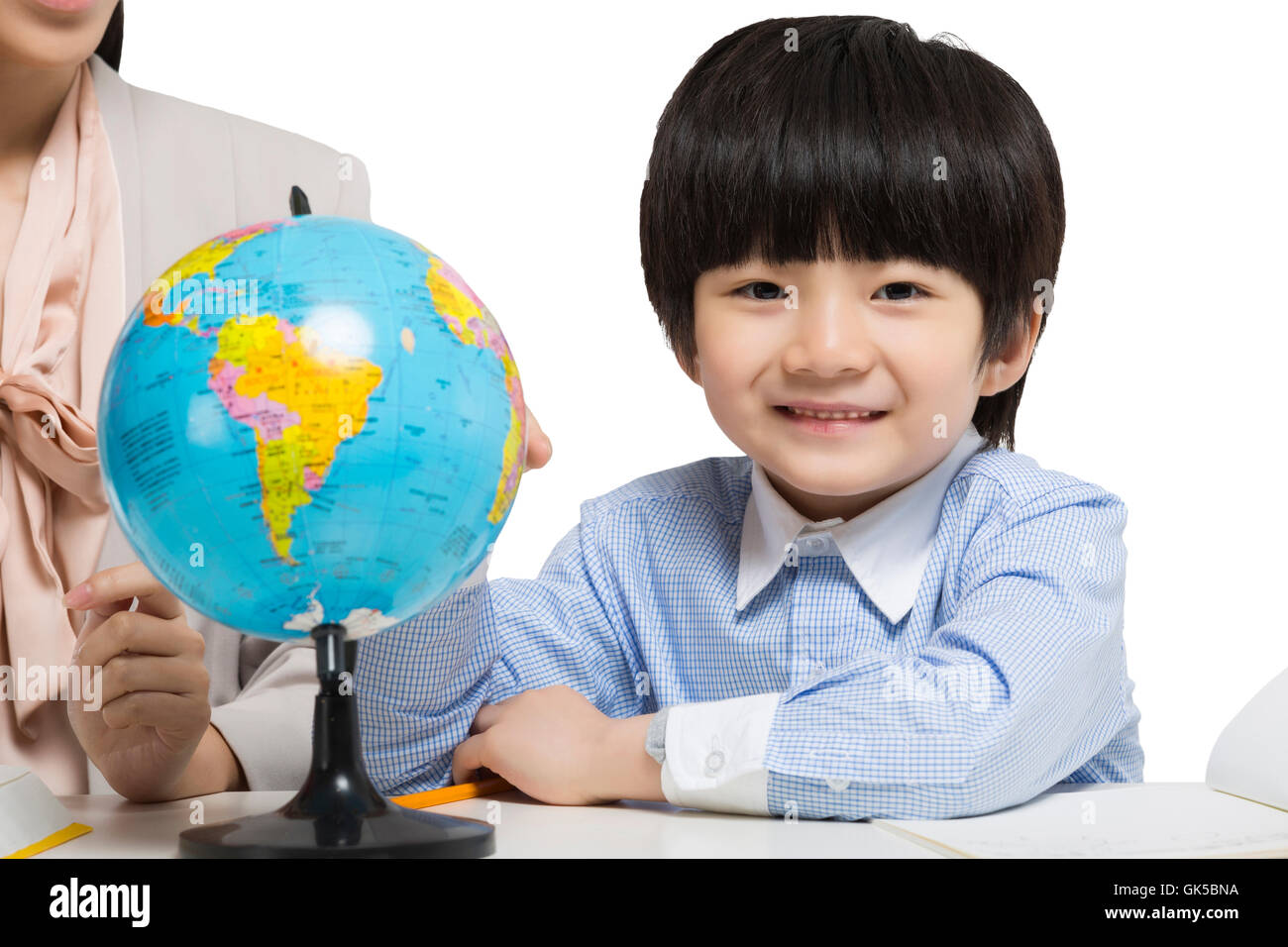 Teacher mentoring young boy learning Stock Photo - Alamy