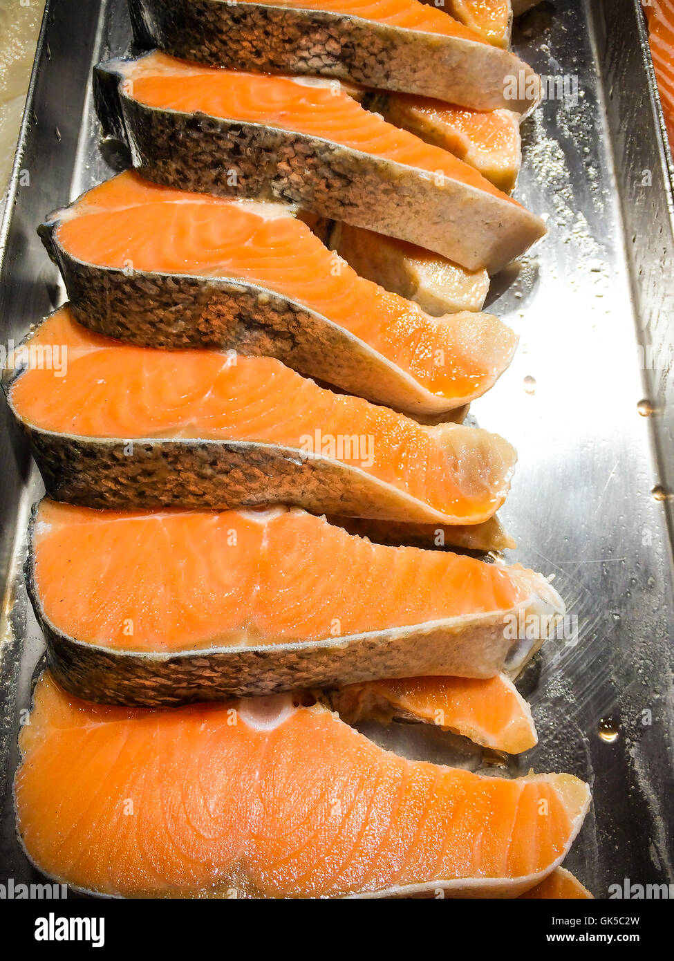 fresh salmon fish in supermarket, slide salmon fish on ice Stock Photo ...