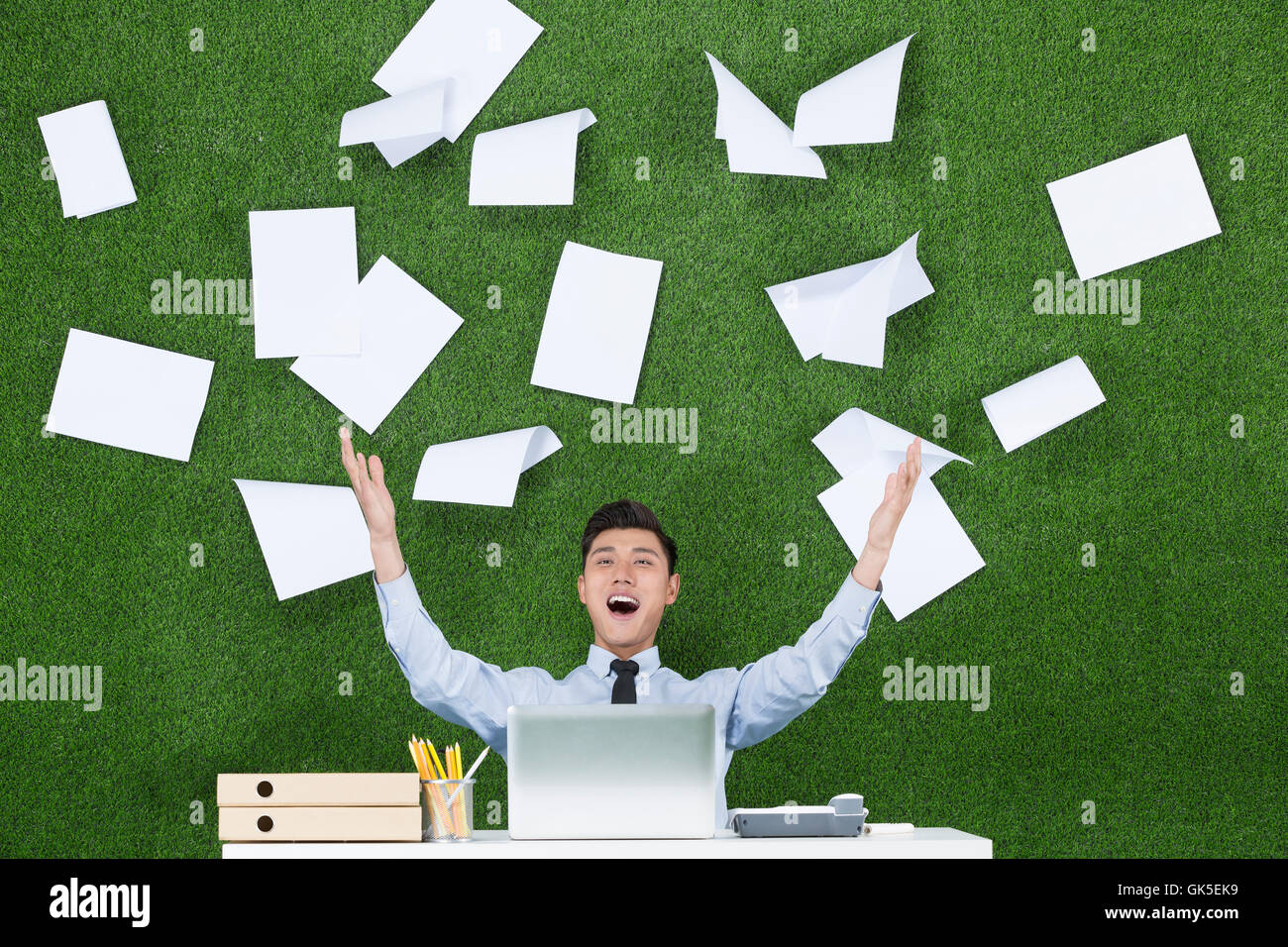 Meadow business man throwing paper in the air Stock Photo - Alamy