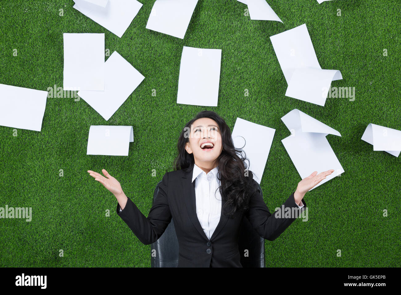 Business lady lawn throwing paper in the air Stock Photo - Alamy