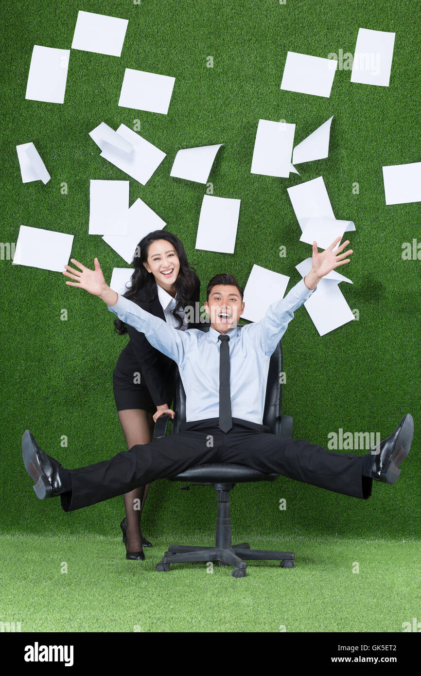 Business women push the air sitting in office chair throwing paper men ...