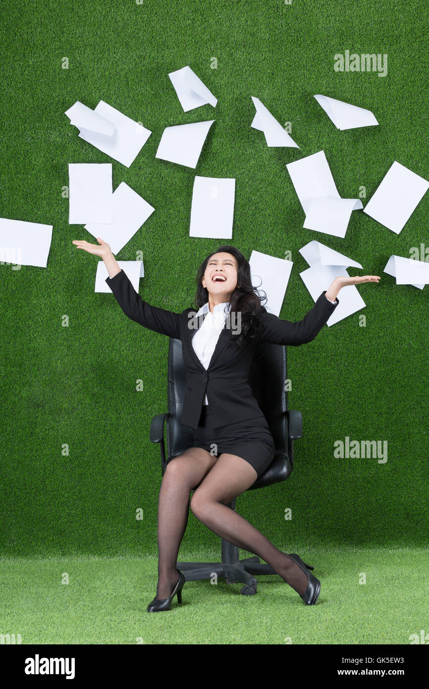 Business lady lawn throwing paper in the air Stock Photo - Alamy