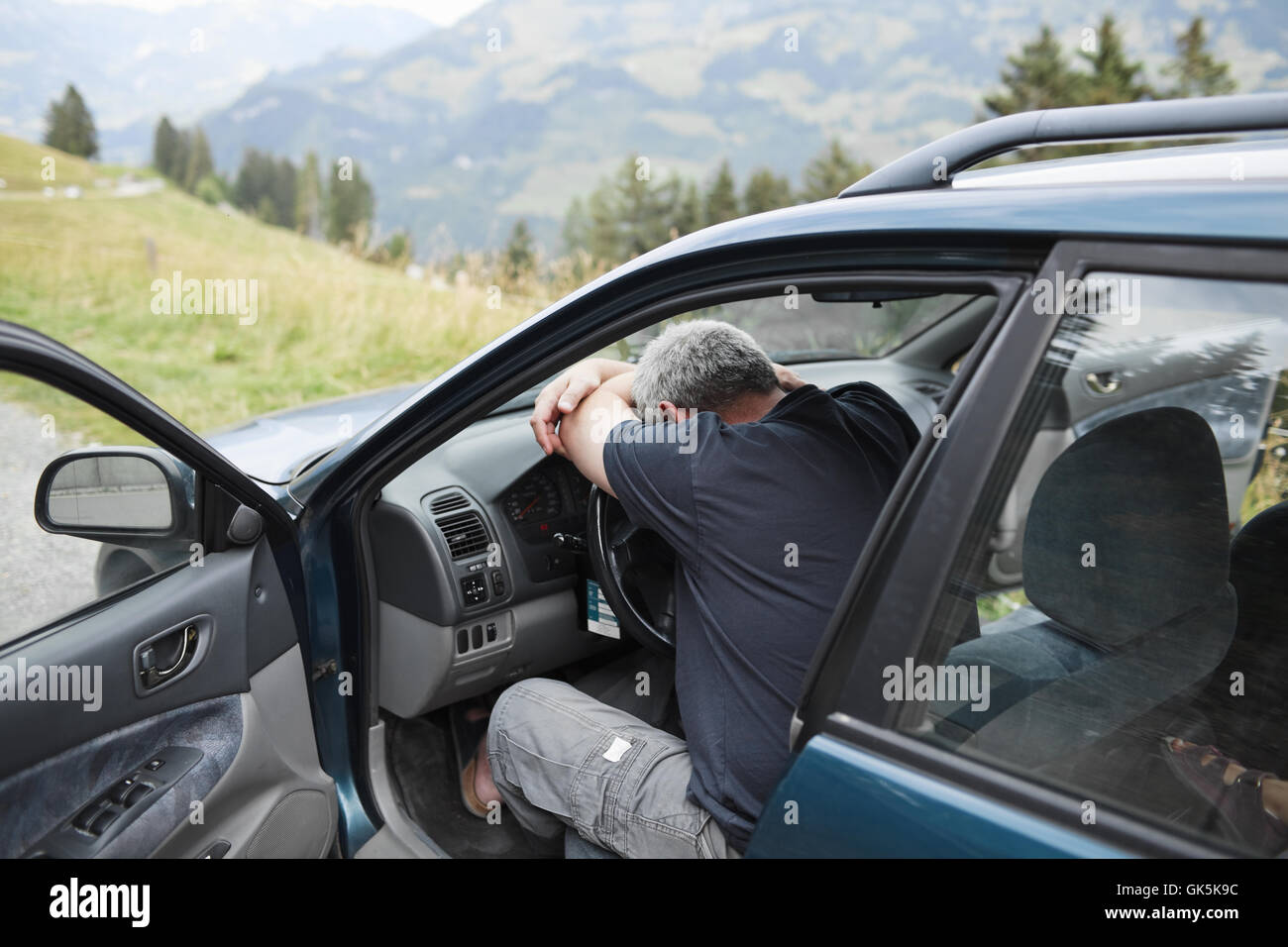 Tired driver sleeping in car Stock Photo - Alamy