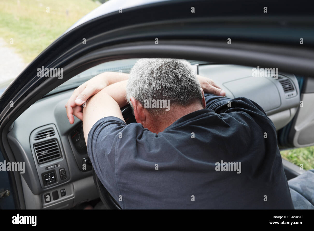 Tired driver sleeping in car Stock Photo - Alamy