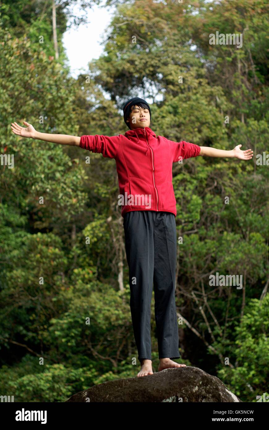 Asian man with outstretched arms at peace with nature outdoors Stock ...