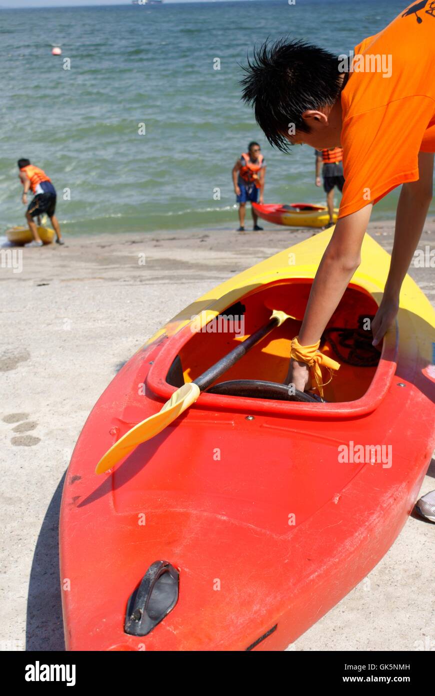 Student canoeing activity at seaside Stock Photo - Alamy