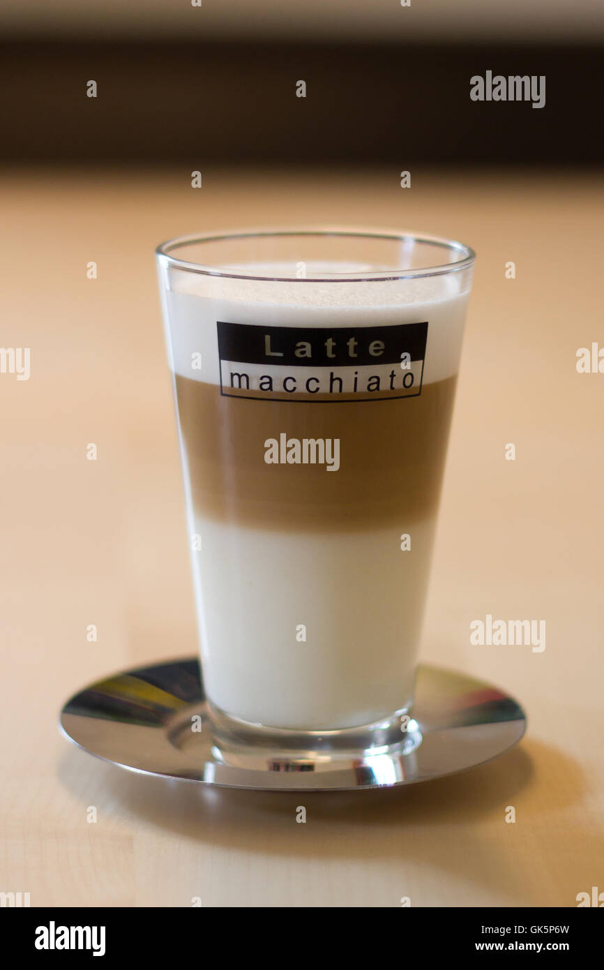 Latte macchiato on saucer Stock Photo - Alamy