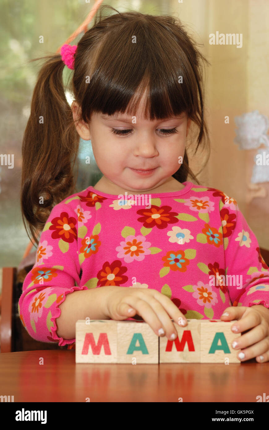 The girl and word mama from cubes Stock Photo - Alamy
