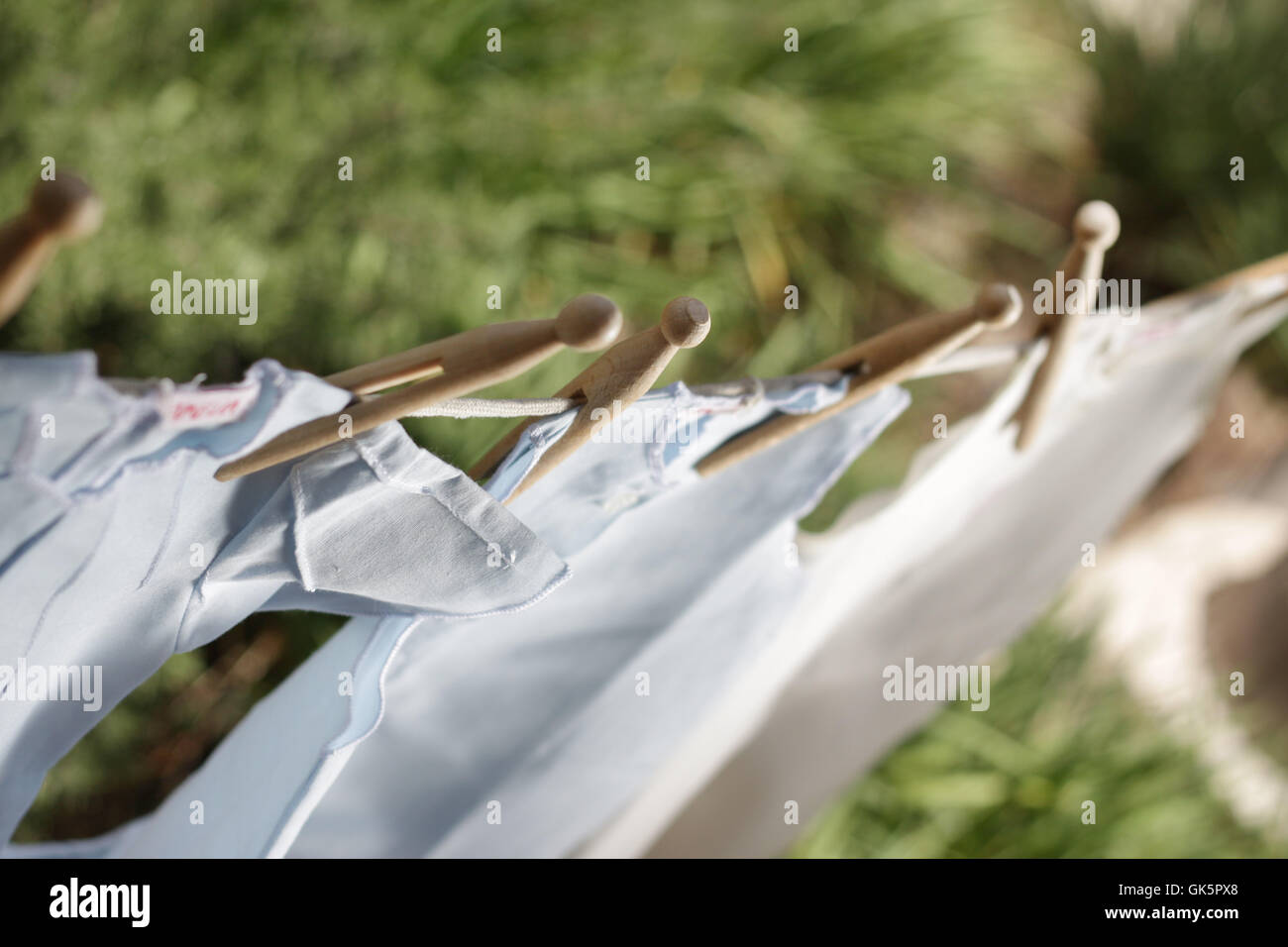 Cute baby clothes drying on a line Stock Photo - Alamy
