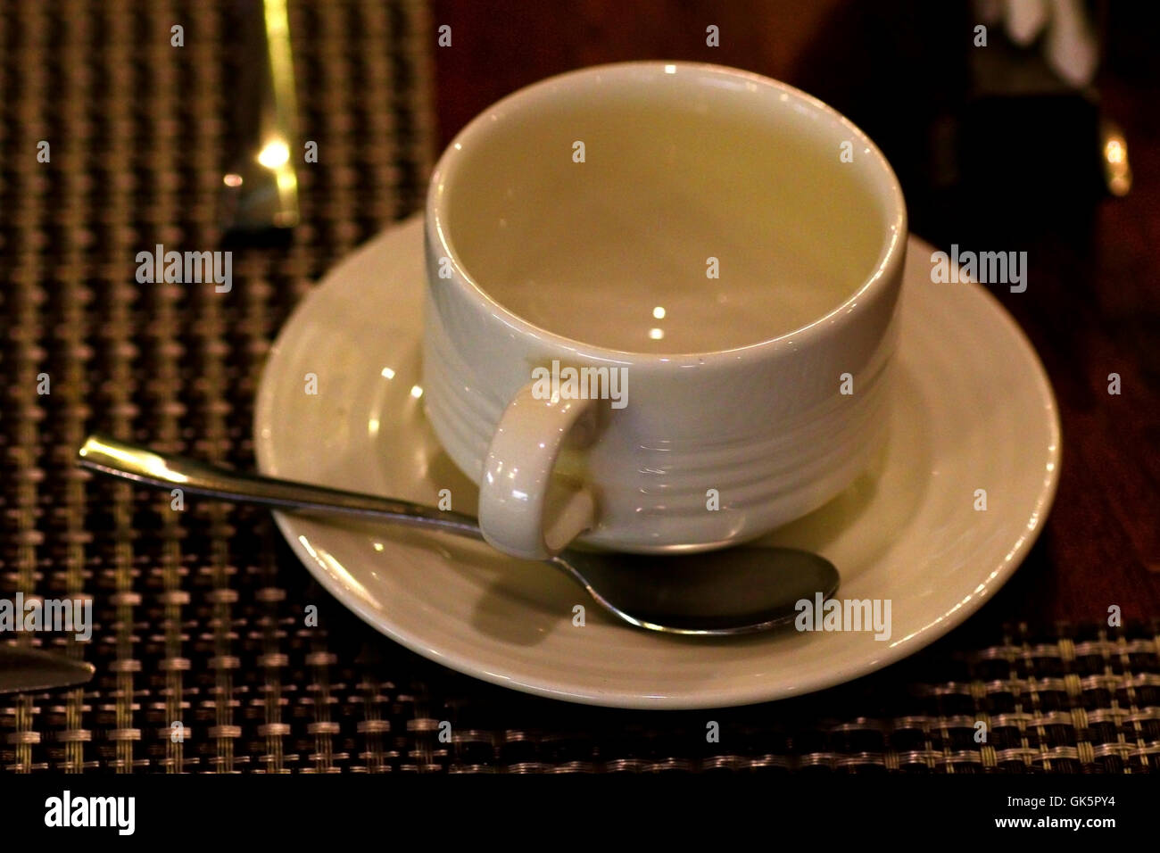 A tea cup and plate on dining table Stock Photo - Alamy