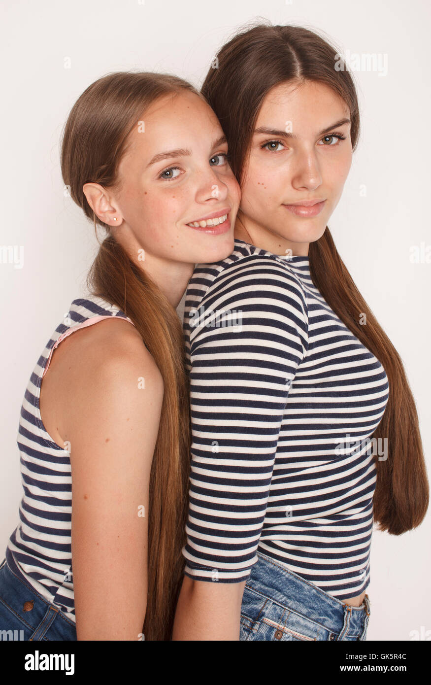 two cute teenagers having fun together isolated on white Stock Photo ...