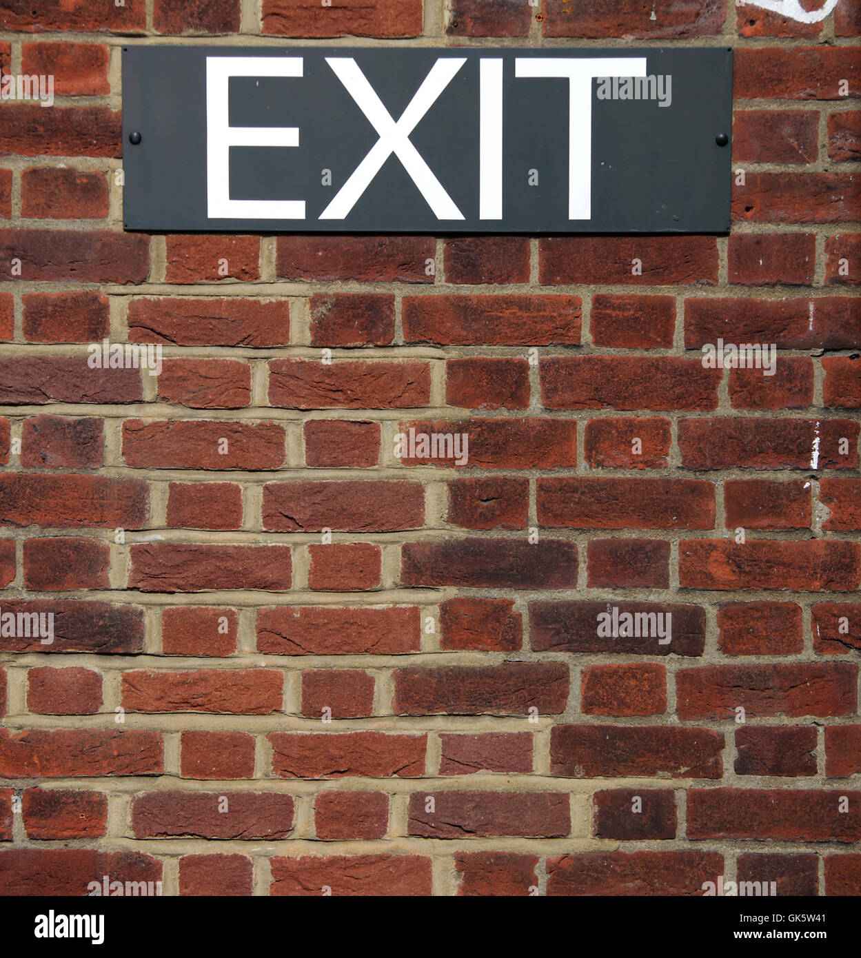 Exit sign on brick wall Stock Photo - Alamy