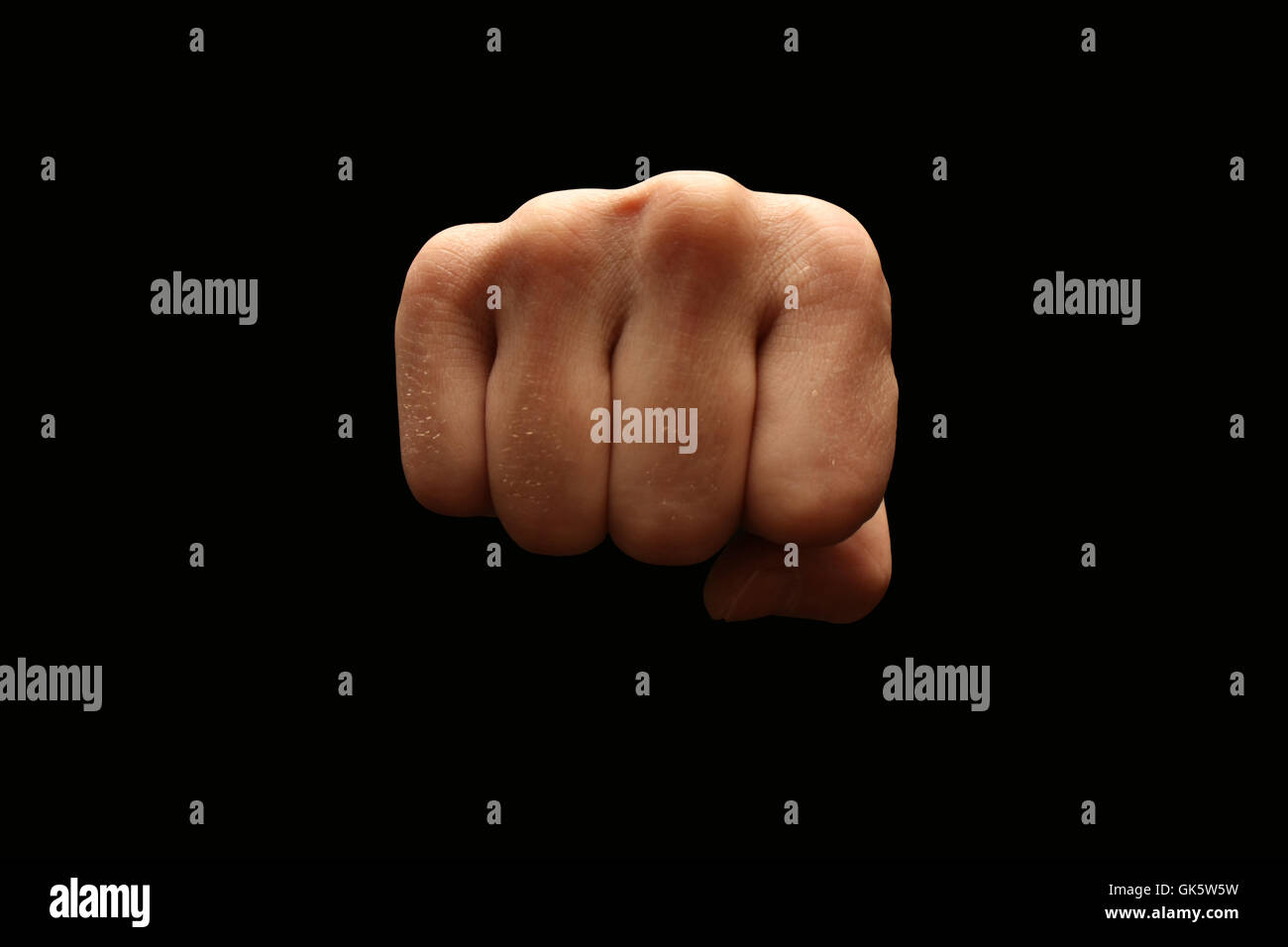 A man∩┐╜s fist isolated on black background Stock Photo - Alamy