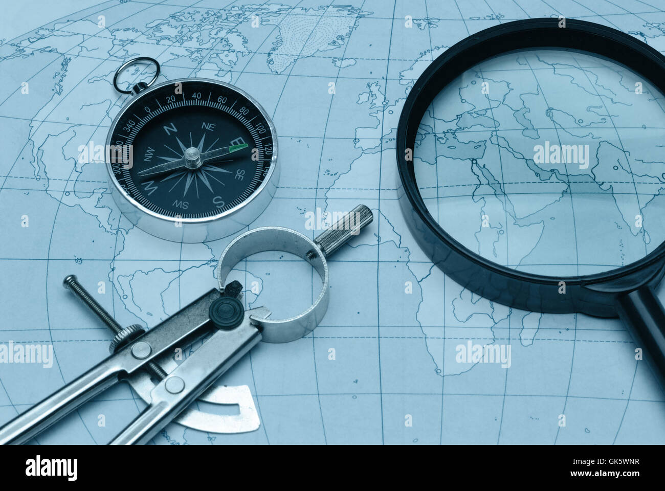 Magnifier , compass and map Stock Photo - Alamy