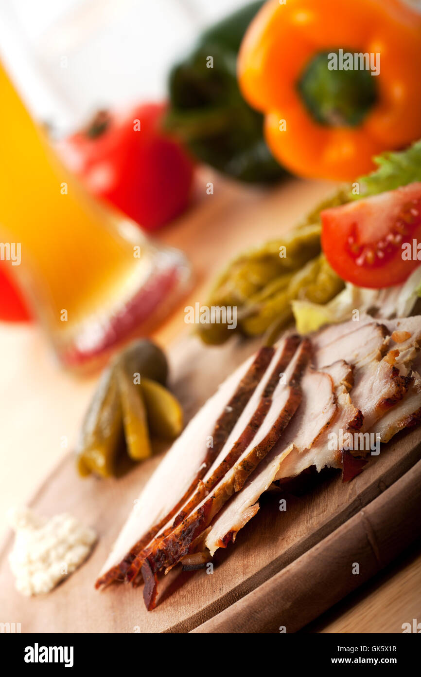 slices of cold roast pork on a wooden plate Stock Photo - Alamy