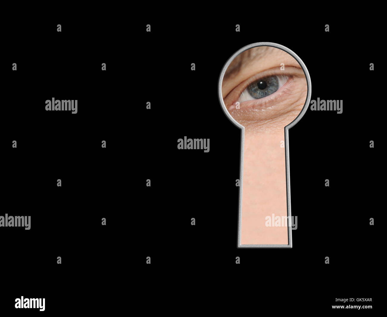 Look through a keyhole in black background Stock Photo - Alamy