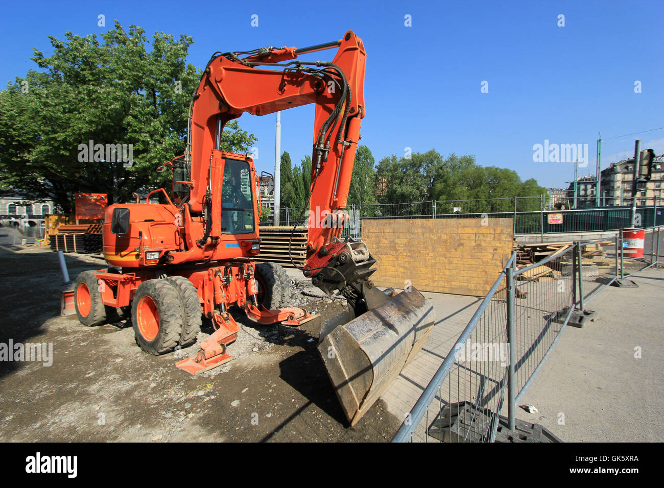 Red mechanical digger in the city Stock Photo - Alamy