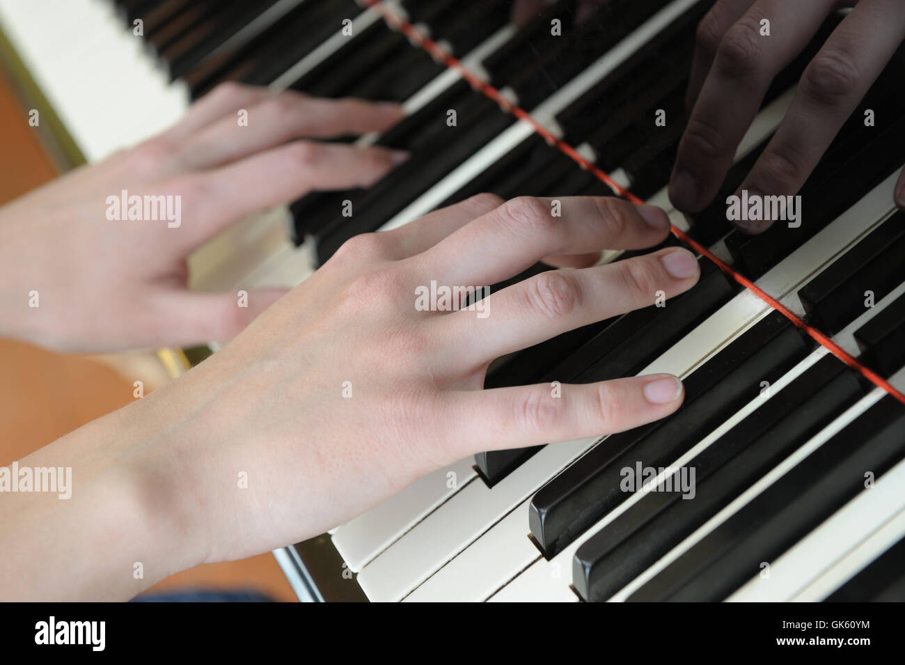 Hands above keys of the piano Stock Photo - Alamy