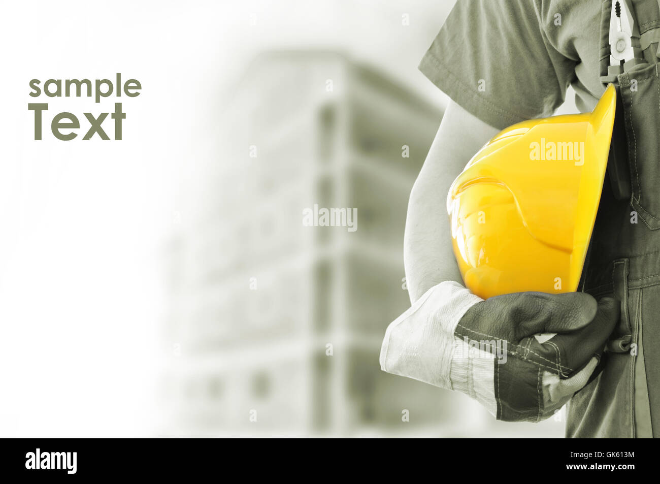 worker with blurred construction in background Stock Photo - Alamy