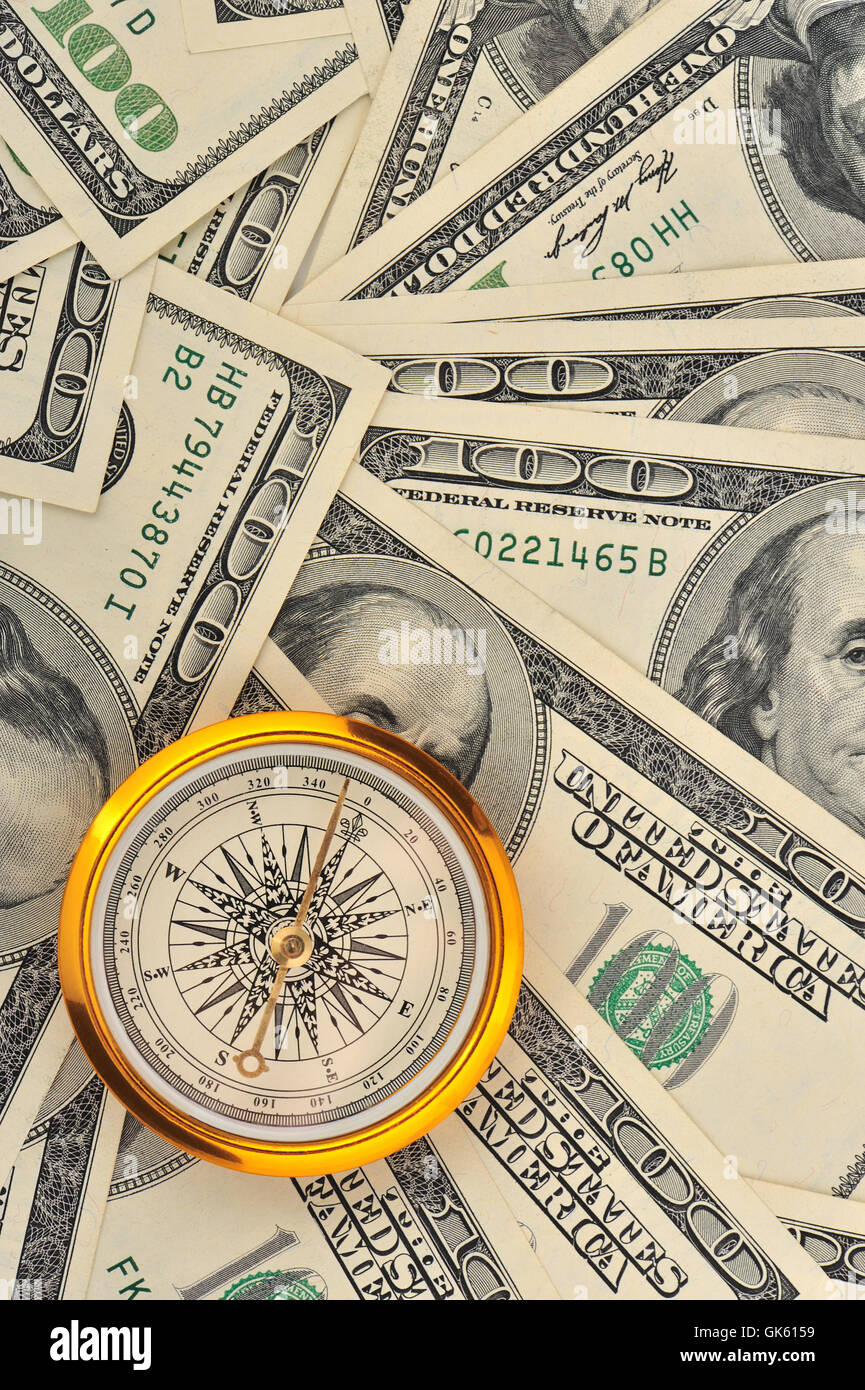 Dollars and compass Stock Photo - Alamy