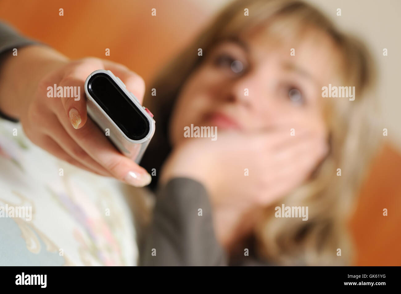 The woman with a television control panel. Selective focus Stock Photo ...