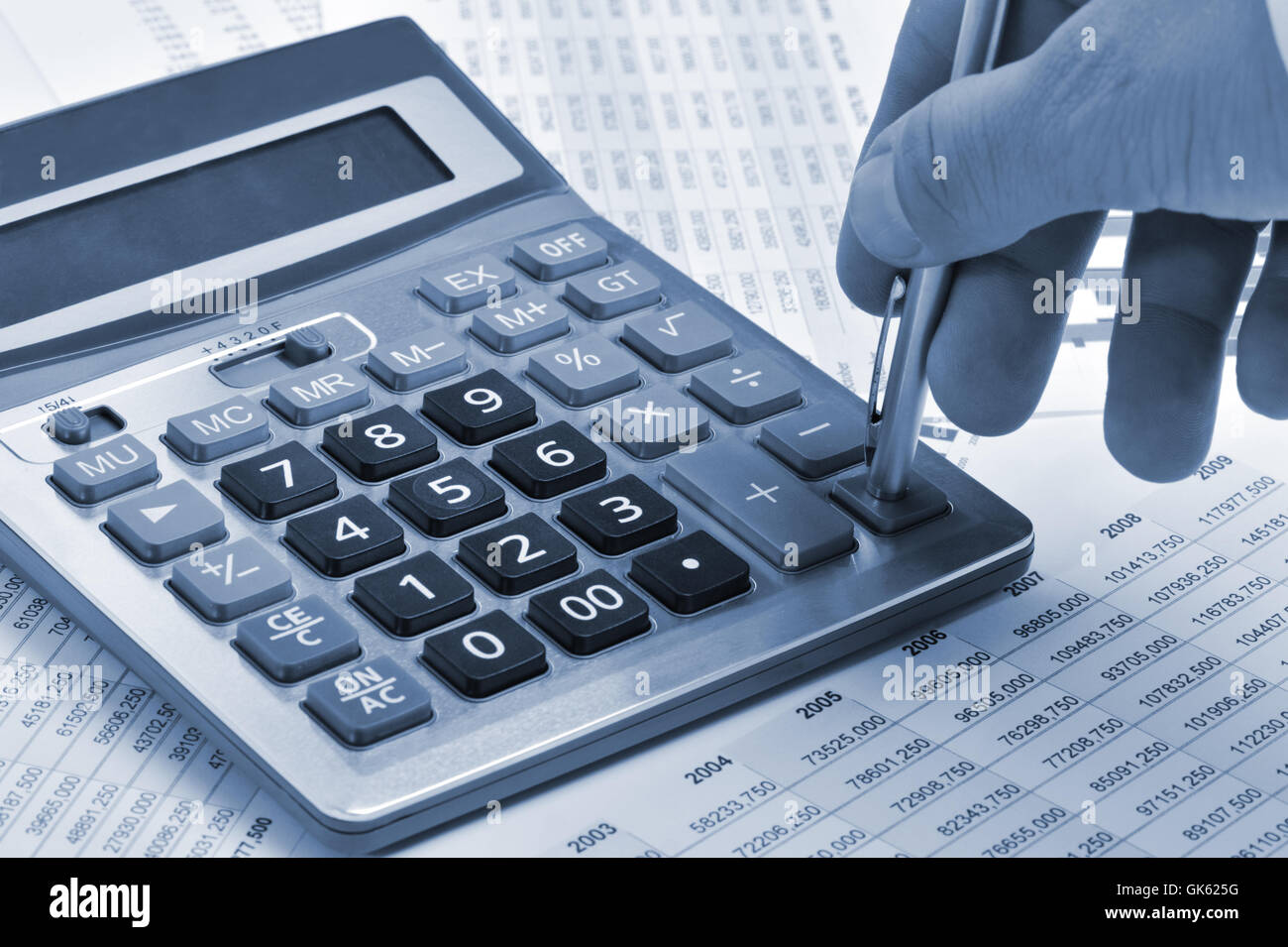 The calculator and a hand of the man Stock Photo - Alamy