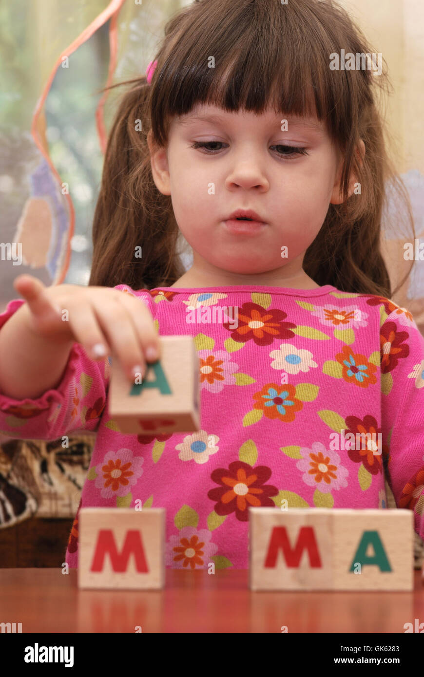 The girl and word mama from cubes Stock Photo - Alamy