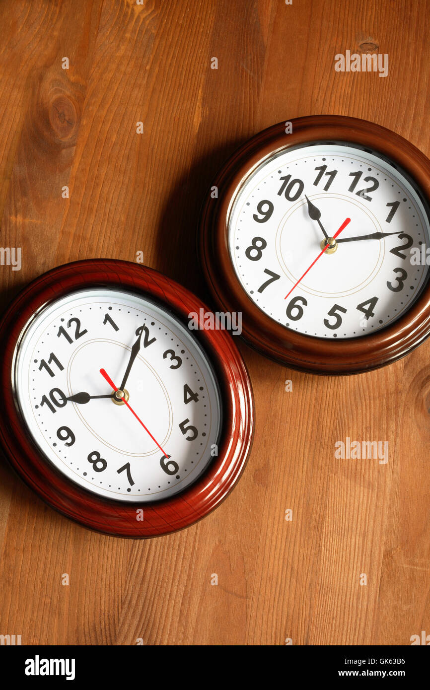 Pair Of Clocks On Wood Stock Photo - Alamy