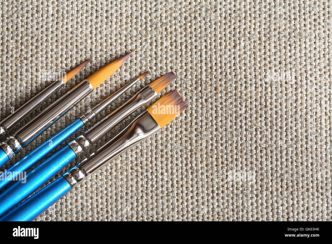 Paintbrushes On Canvas Stock Photo - Alamy