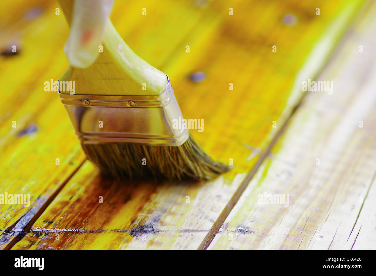 brush applying a layer of protective lacquer on the wood table Stock ...