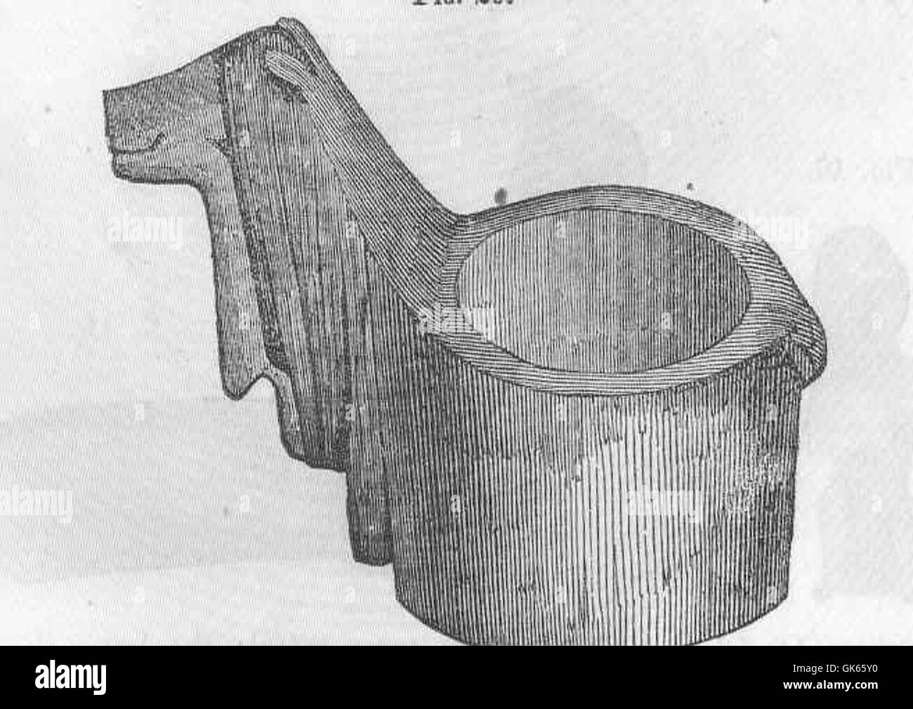 A stone drinking cup, likely of ancient origin, demonstrates the use of ...