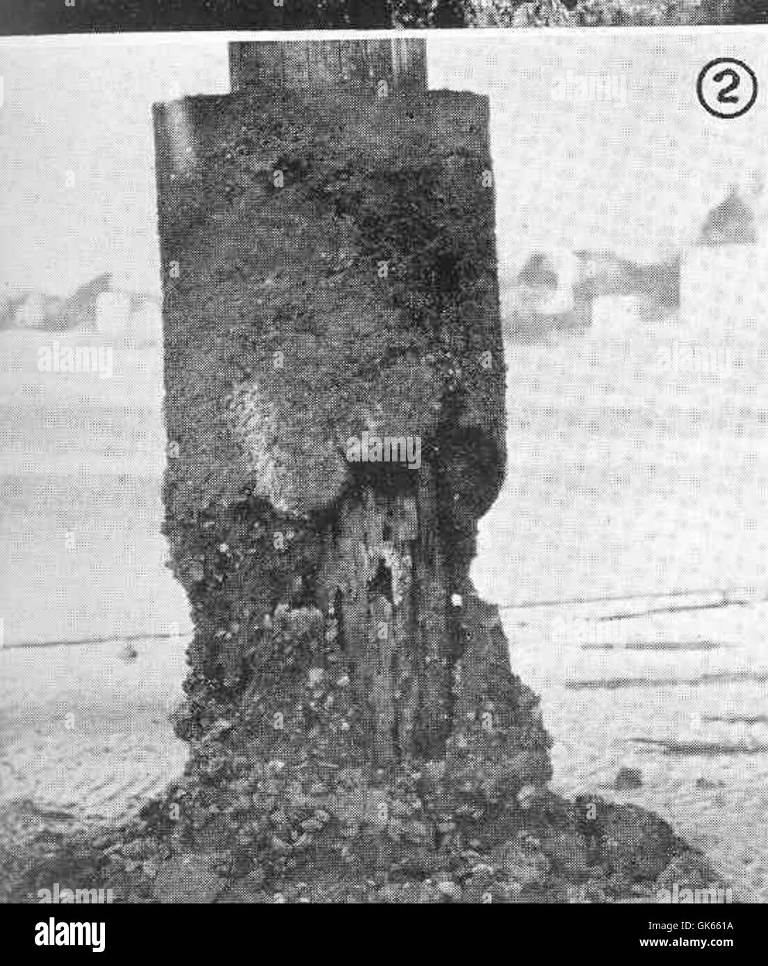 The disintegration of a concrete jacket surrounding a pile, previously ...